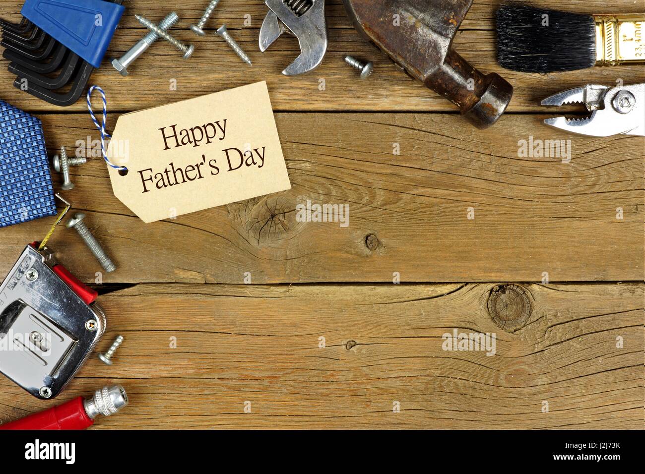 Happy Father's Day tag and corner border of tools on rustic wood ...