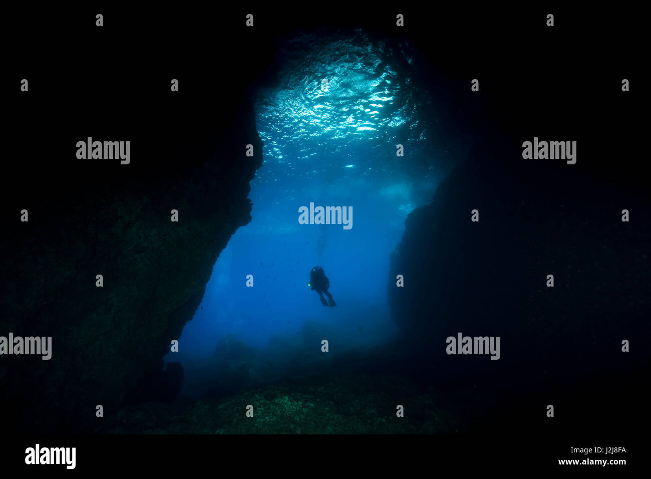 Underwater entrance of a cave with diver, the Azores, St. Maria ...