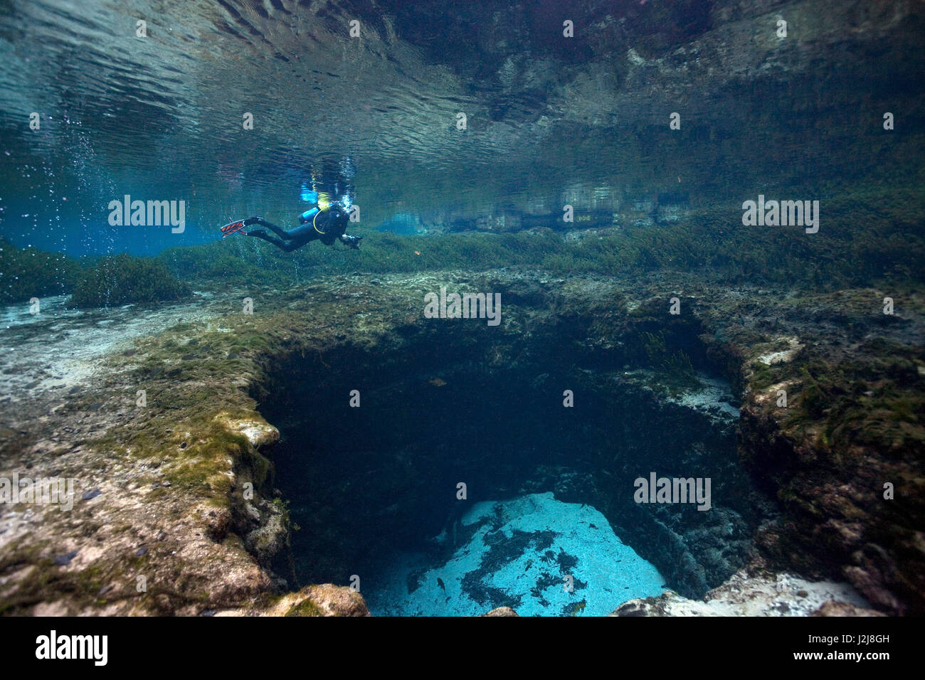 Diver in Devil's Eye source at the entrance to the gigantic pit system ...