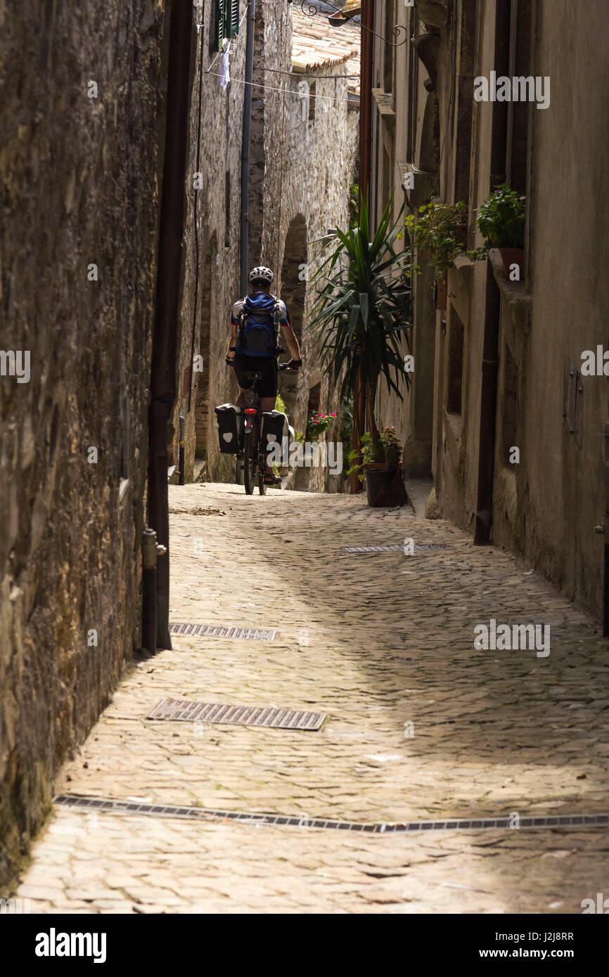 A man with bicycle in a narrow lane in Italy Stock Photo - Alamy