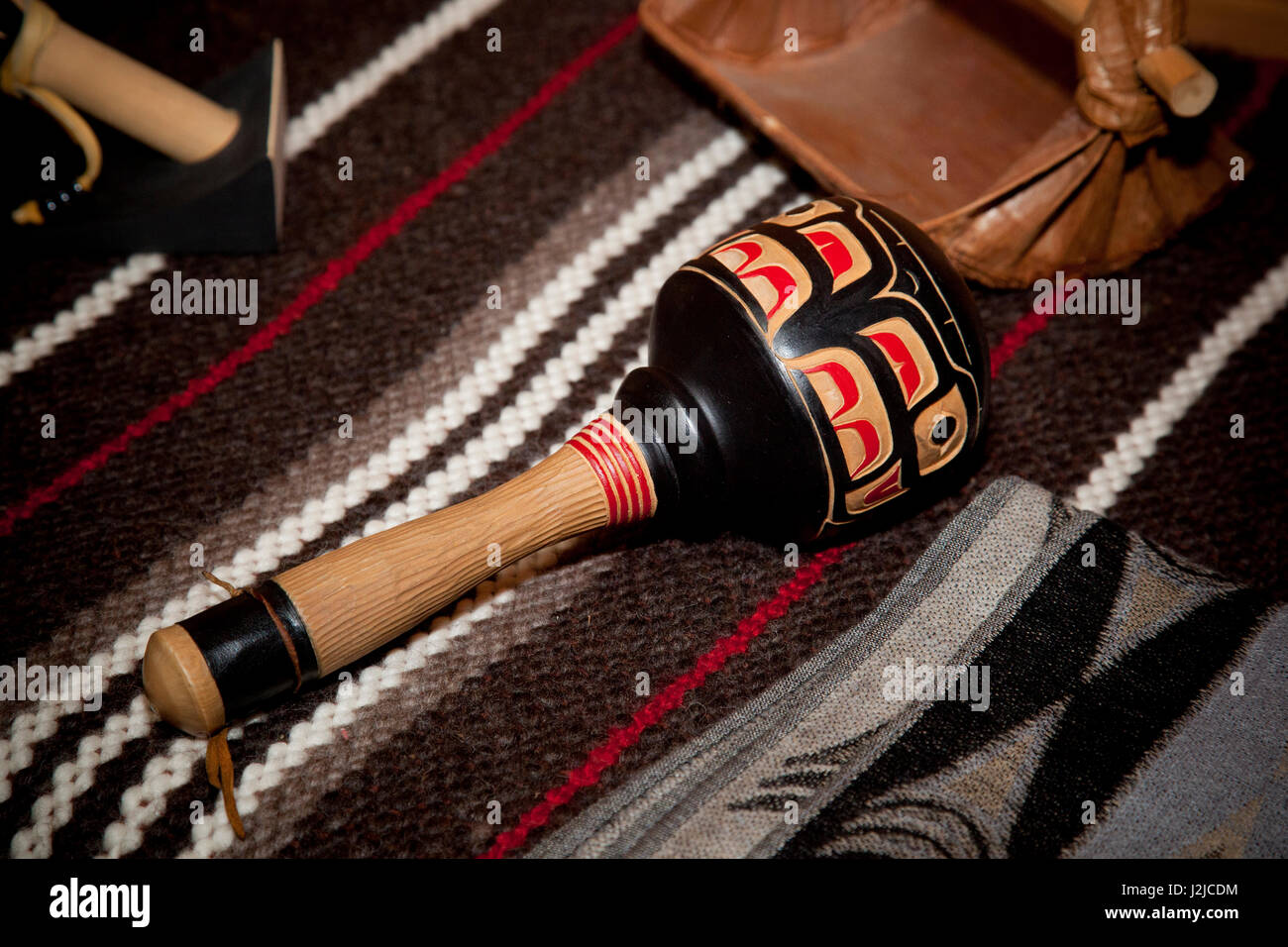 Traditional Coast Salish carved cedar wood ceremonial rattle displayed ...