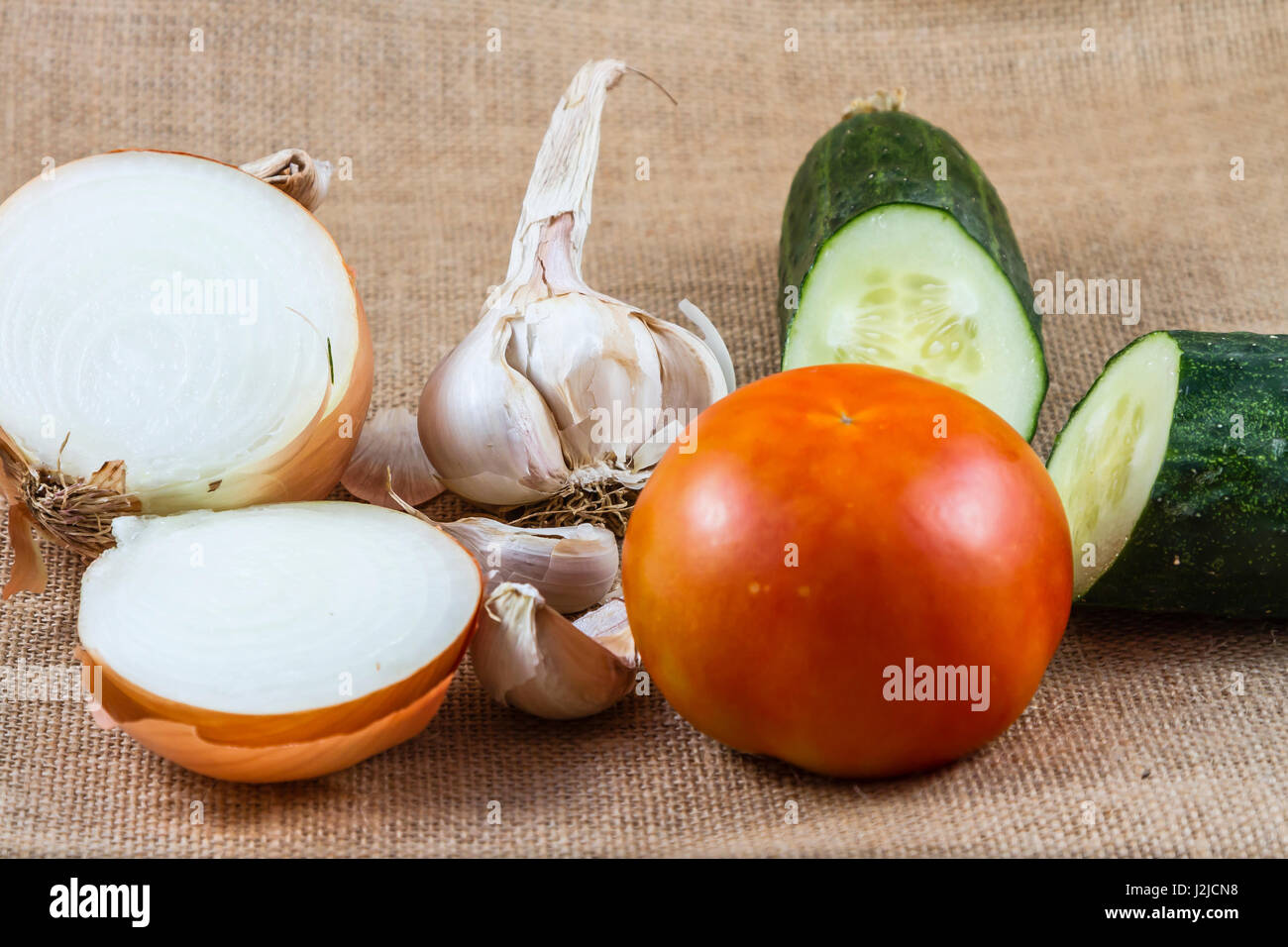 onion, garlic, tomato and cucumber on raffia fabric Stock Photo - Alamy