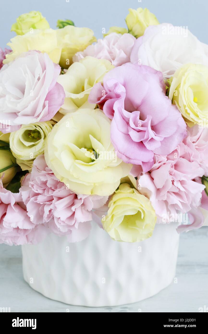 Floral arrangement with pink carnation and yellow eustoma flowers ...