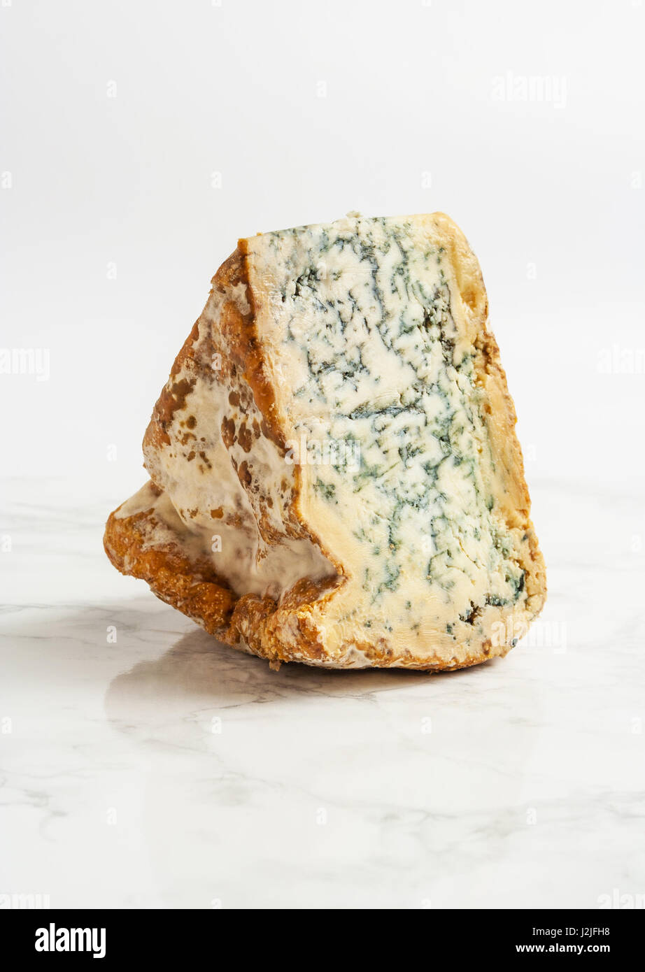 A piece of artisanal blue cheese, straight from the farm Stock Photo ...