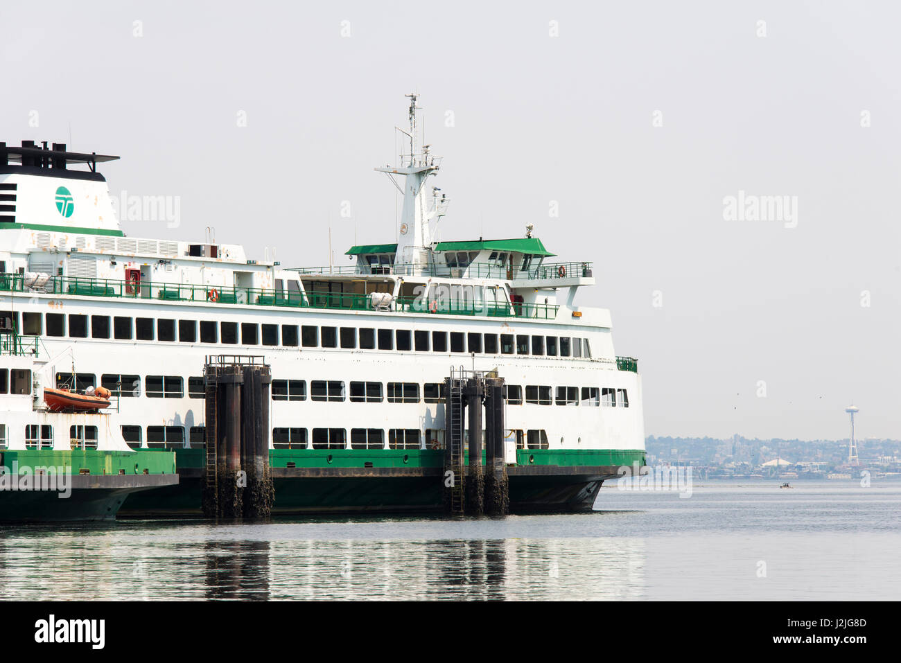 Eagle Harbor, ferry arrives Bainbridge from Seattle. Space Needle ...