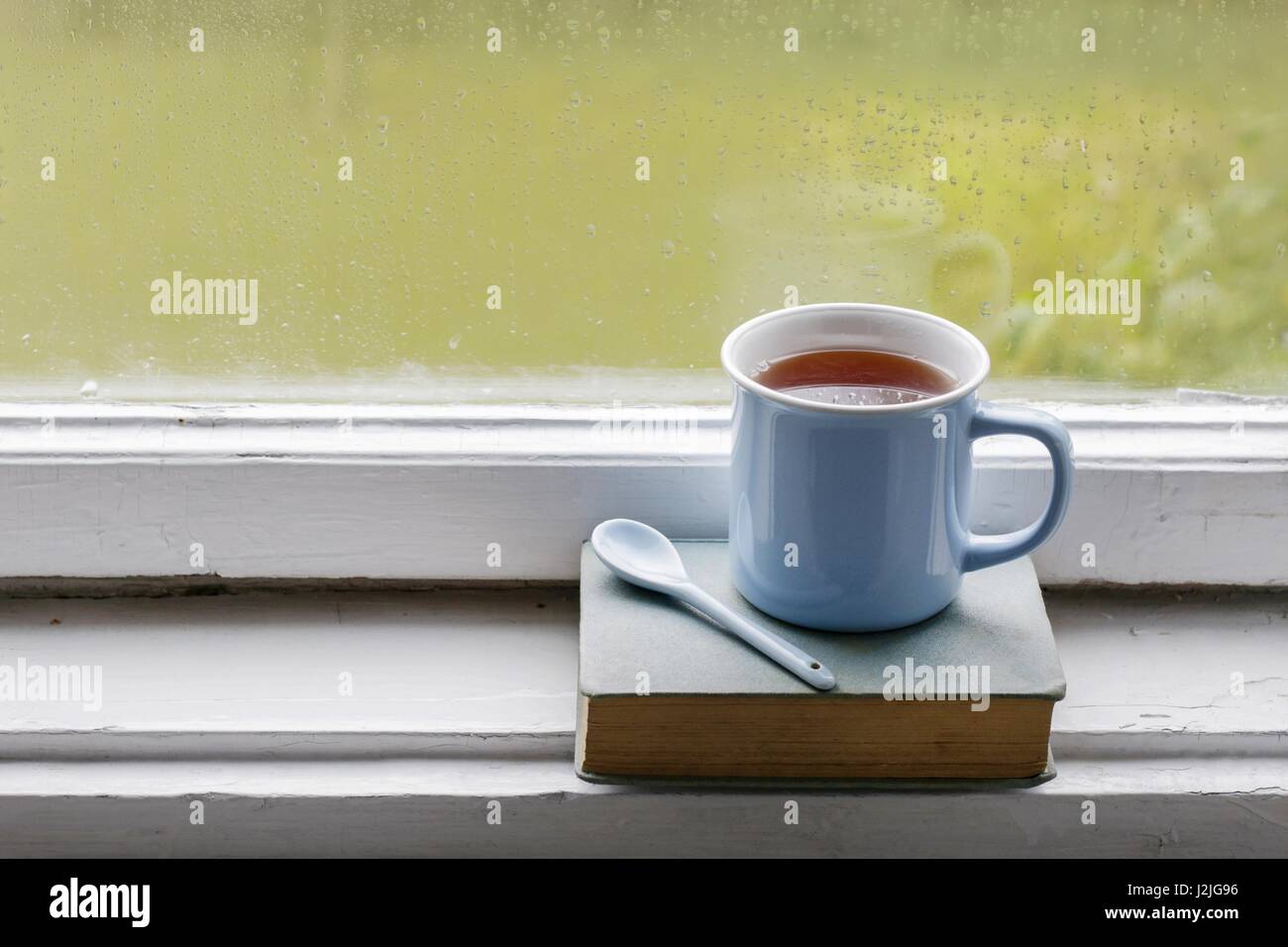 Mug of hot, steaming tea standing by the window Stock Photo - Alamy