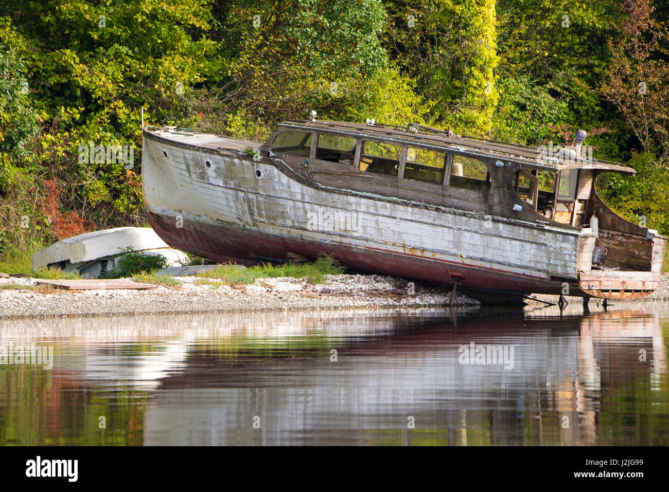 Ostrich Bay, Dyes Inlet beached boat needing repair Stock Photo - Alamy