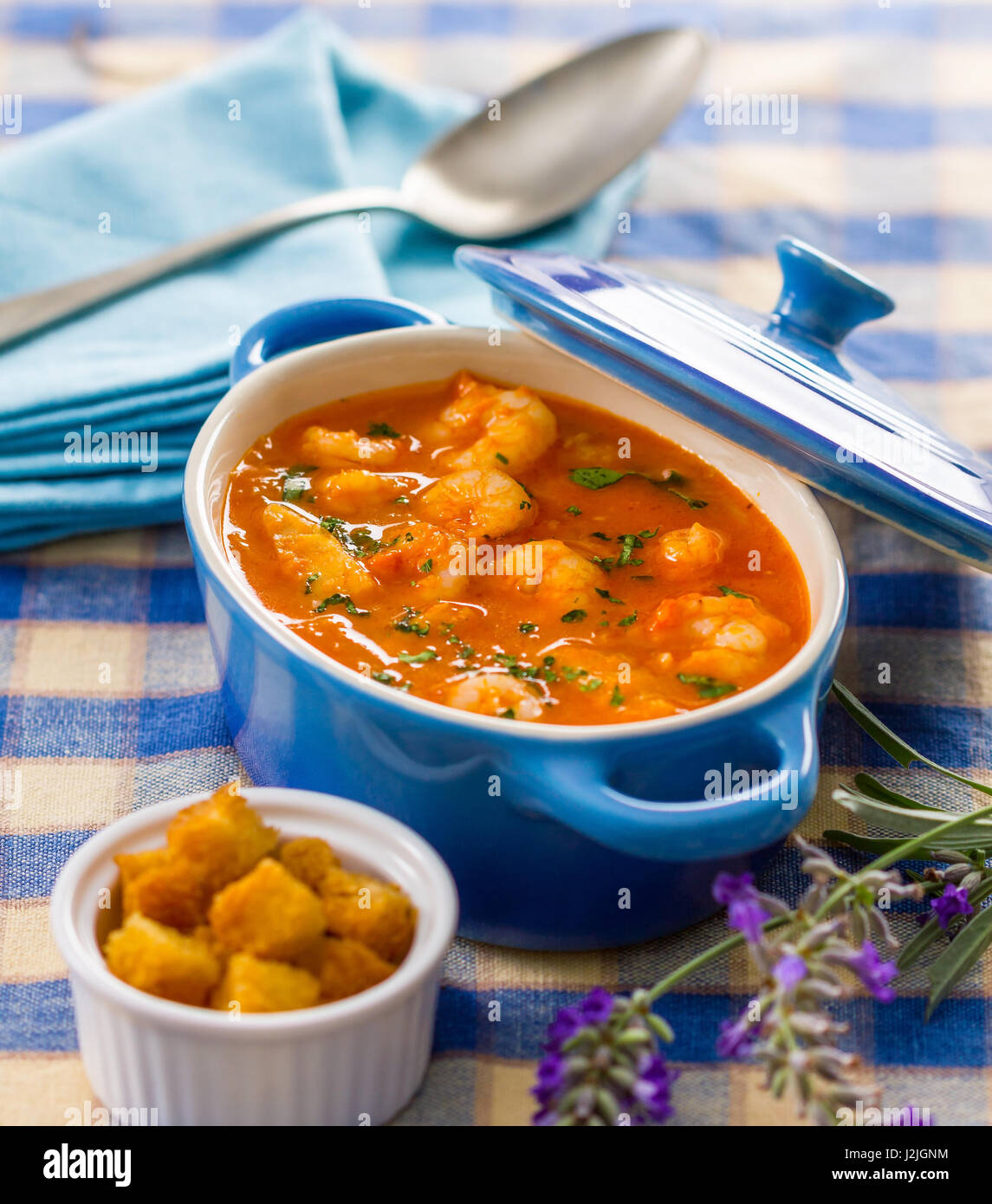 A small blue cooking pot with a delicious Mediterranean seafood soup ...