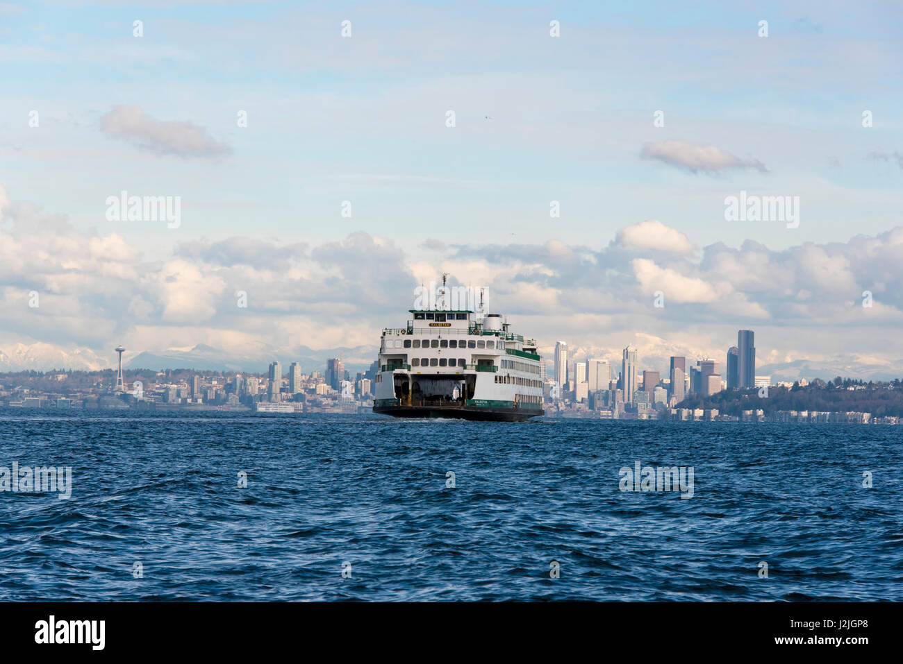 USA, Washington State, Seattle. Ferry heading toward waterfront skyline ...