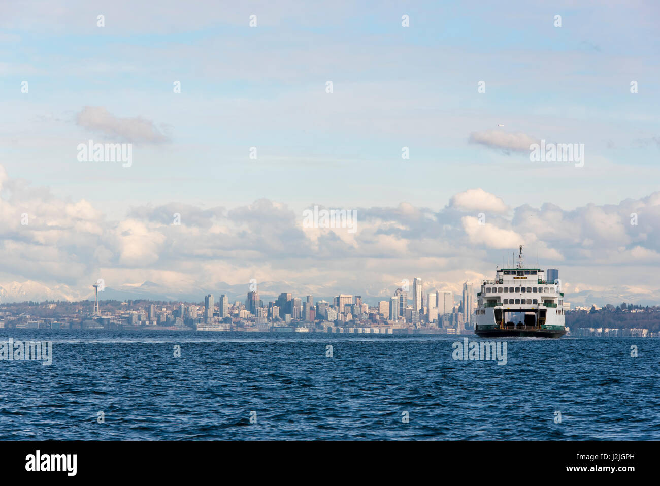 USA, Washington State, Seattle. Ferry heading toward waterfront skyline ...