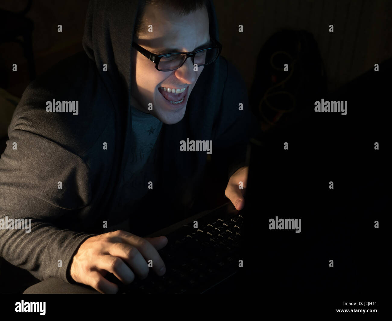 Computer hacker man stealing information with laptop Stock Photo - Alamy