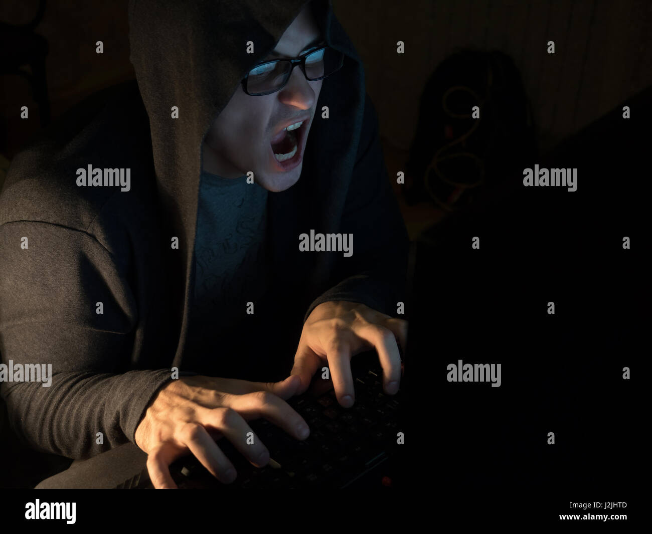 Computer hacker man stealing information with laptop Stock Photo - Alamy