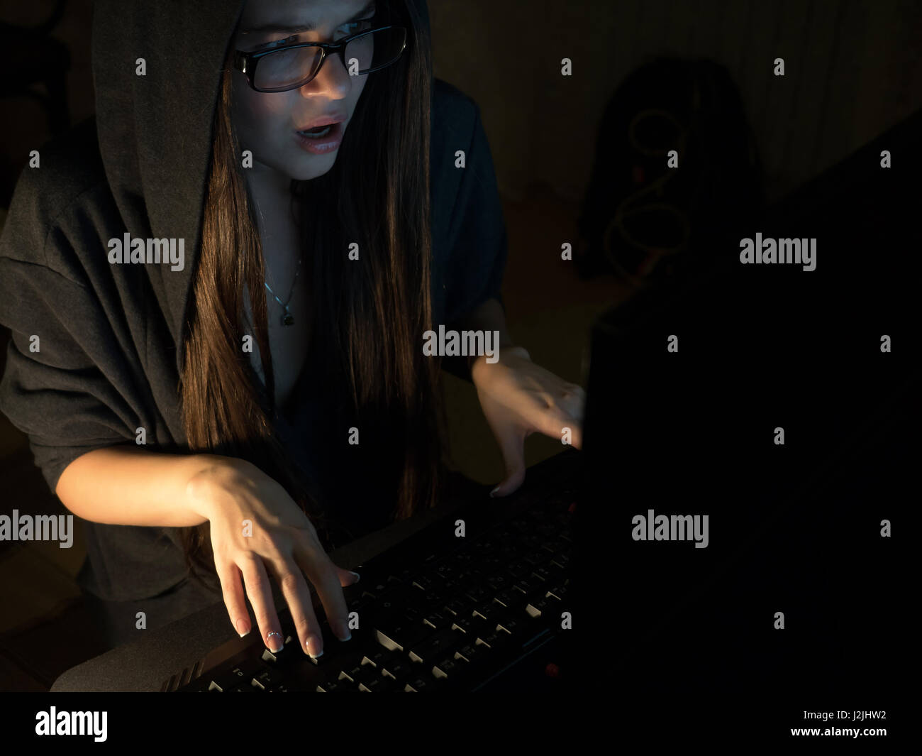 Computer hacker girl stealing information with laptop Stock Photo - Alamy