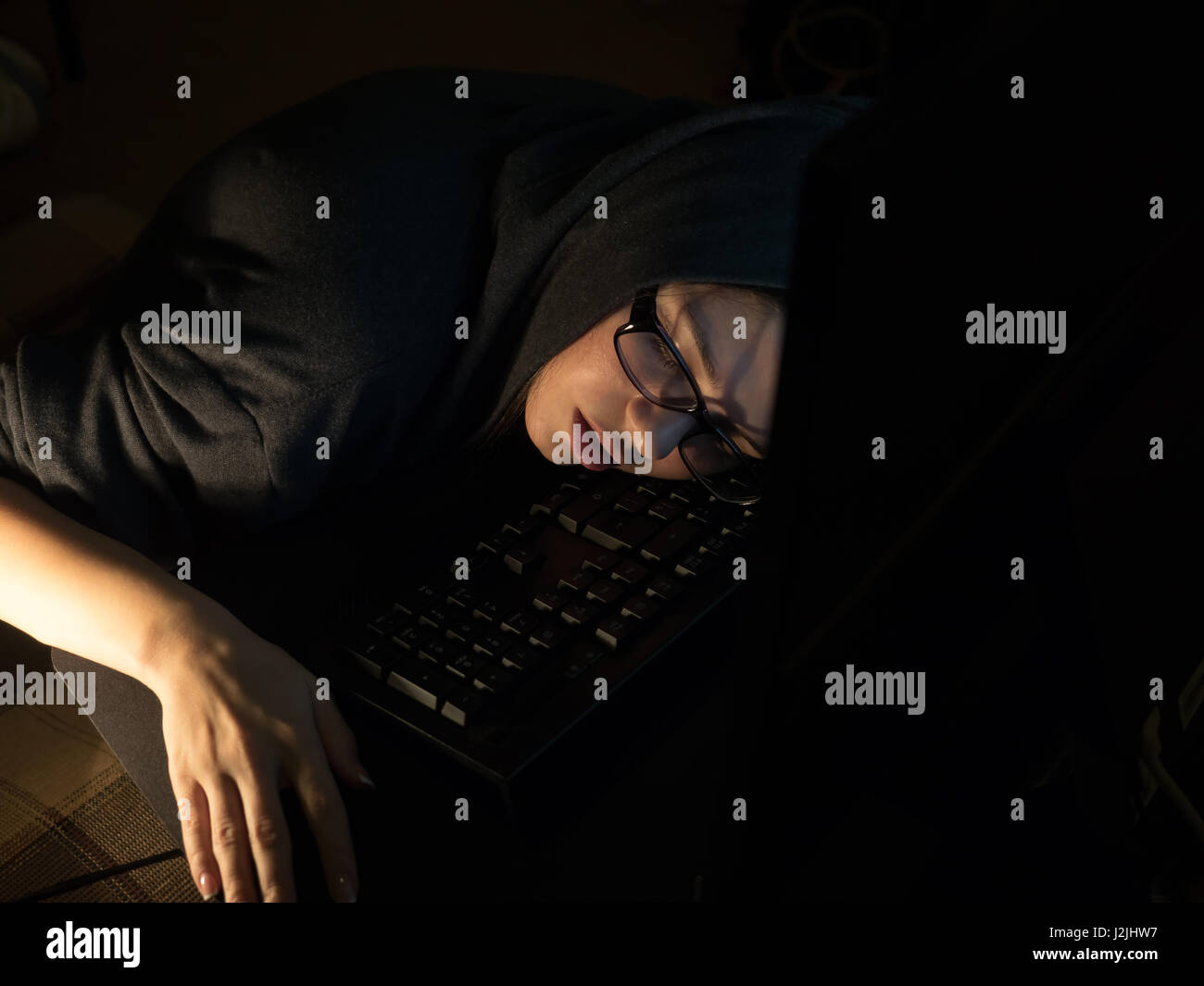 Hacker girl is sleeping beside the laptop Stock Photo - Alamy
