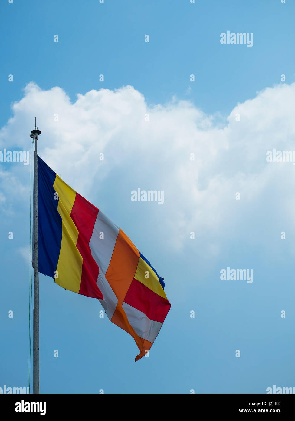 Buddhist flag against the cloudy sky background Stock Photo - Alamy