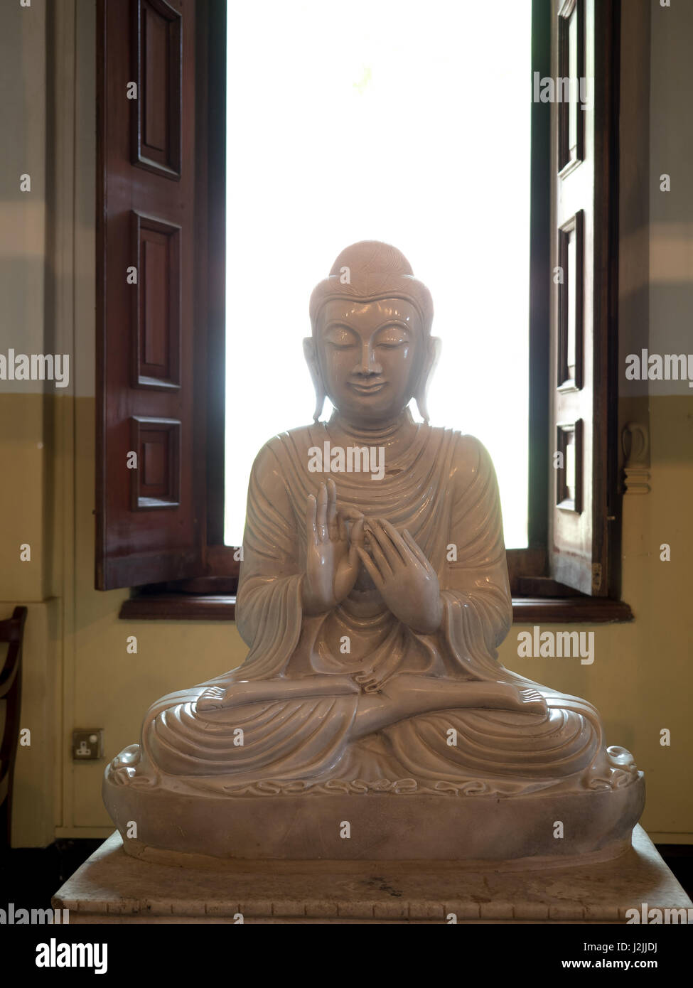 Buddha statue with a opened window backround Stock Photo - Alamy