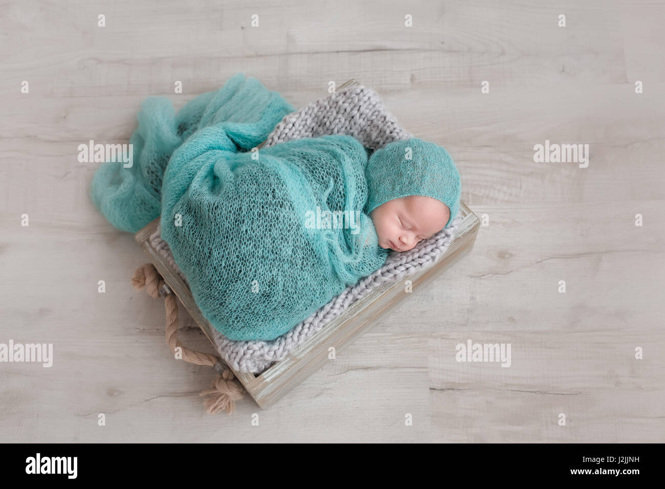 Sleeping newborn baby girl swaddled in a blanket in a box Stock Photo ...