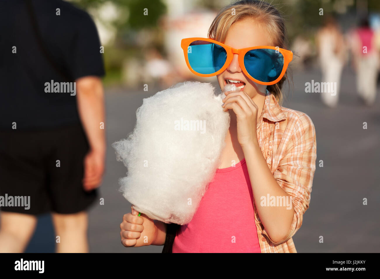 School girl eating cotton candy Stock Photo - Alamy