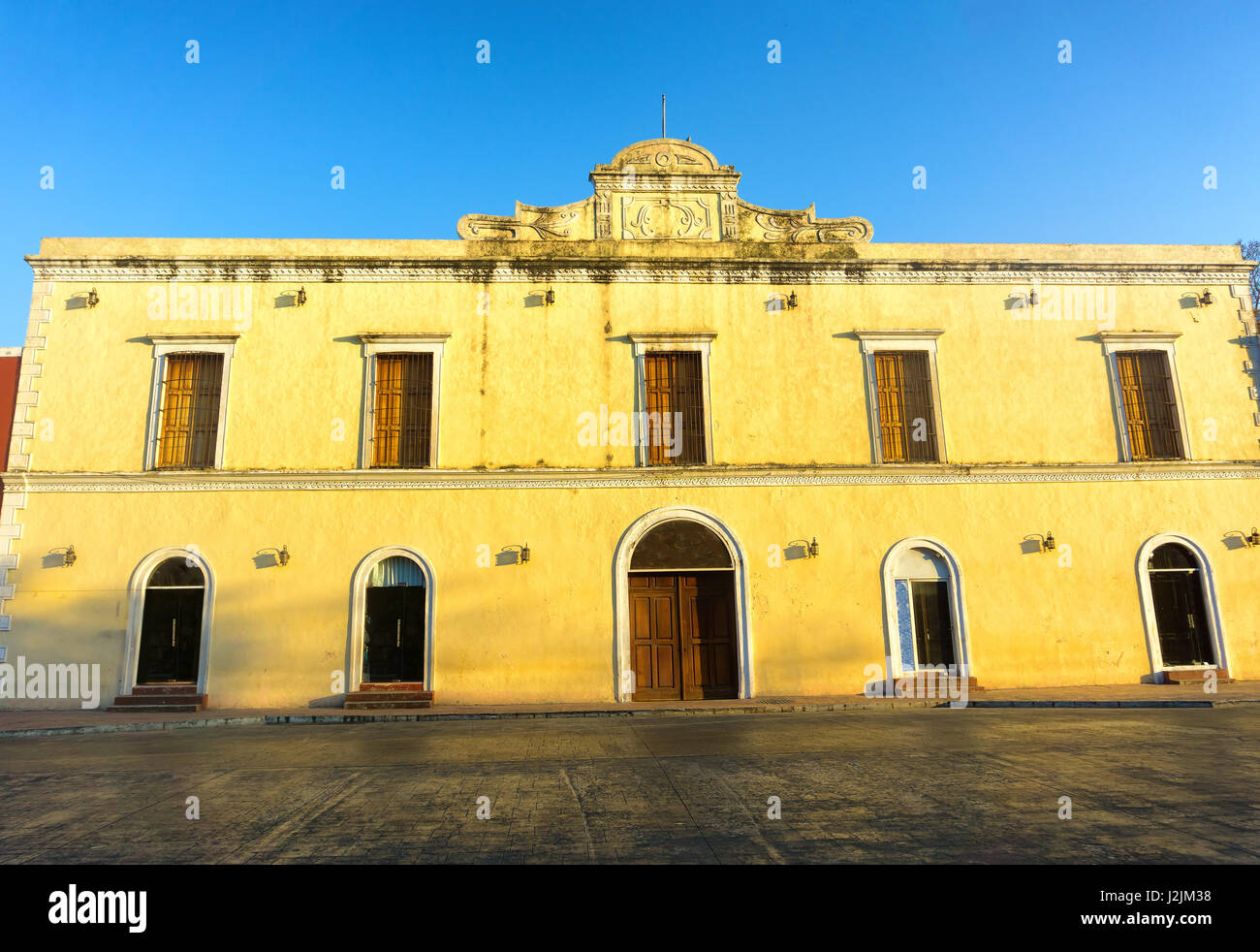Yellow colonial building with a blue sky in Valladolid, Mexico Stock ...