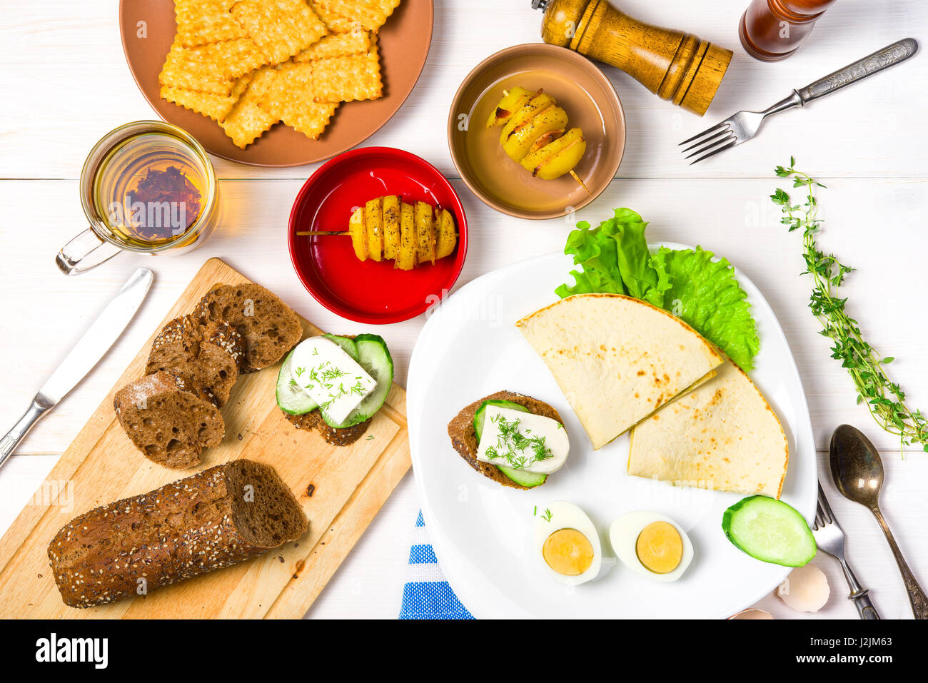 Breakfast or lunch for two on white table. Top view Stock Photo - Alamy