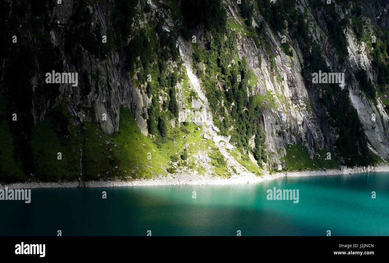 Ray of light hitting the lake surface and mountain face Stock Photo - Alamy