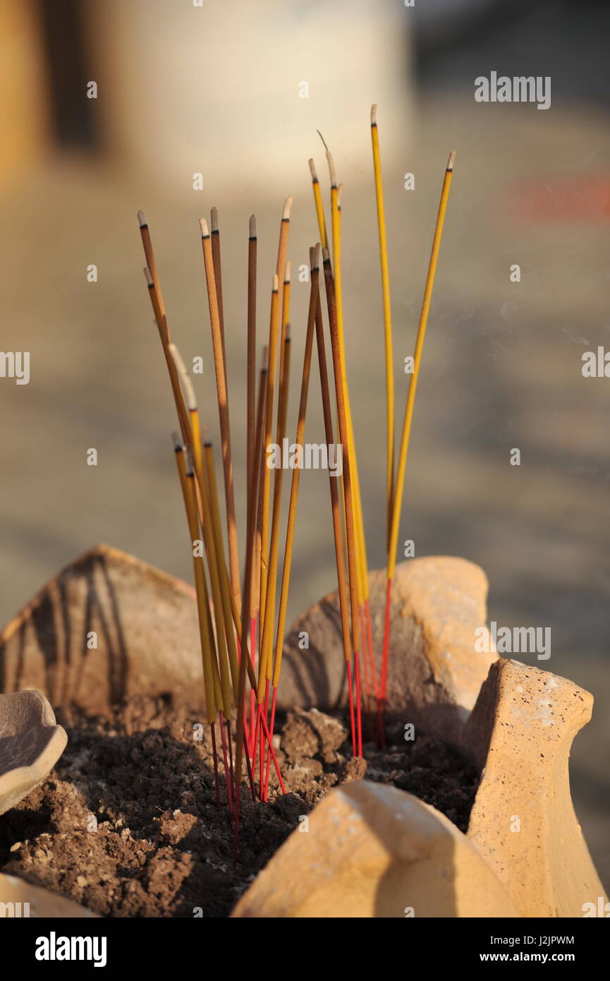 Incense is lit at a small temple on the riverside to celebrate Khmer ...