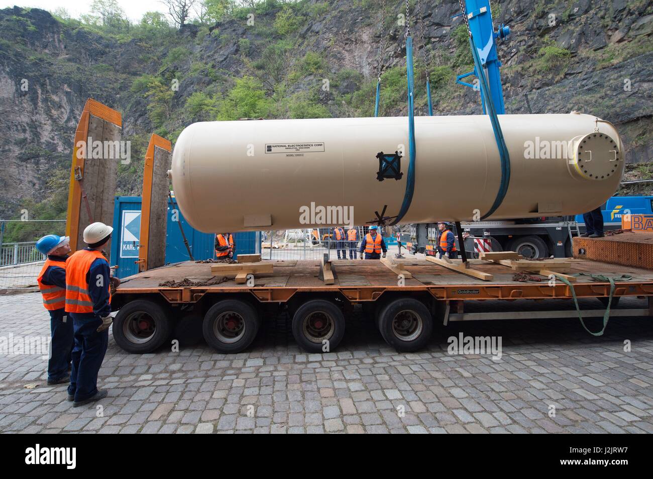 An eight-meter-long and ten-ton particle accelerator tank hanging from ...
