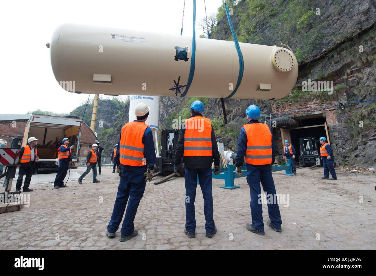 An eight-meter-long and ten-ton particle accelerator tank hanging from ...