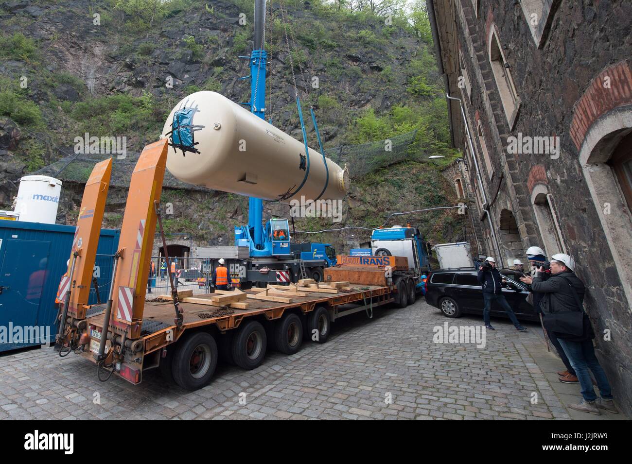 An eight-meter-long and ten-ton particle accelerator tank hanging from ...