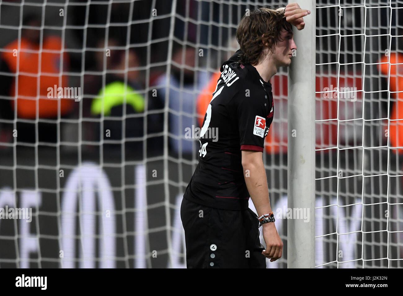 Leverkusen's Tin Jedvaj leans on the goalpost after the 1-4 loss of the ...