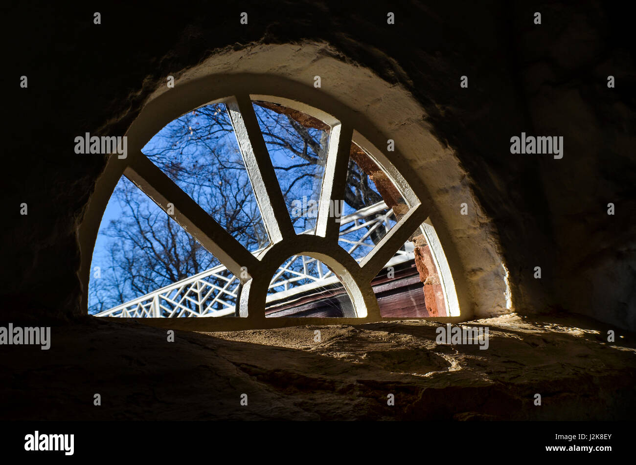 Small window opening in dark room to blue sky and trees Stock Photo - Alamy