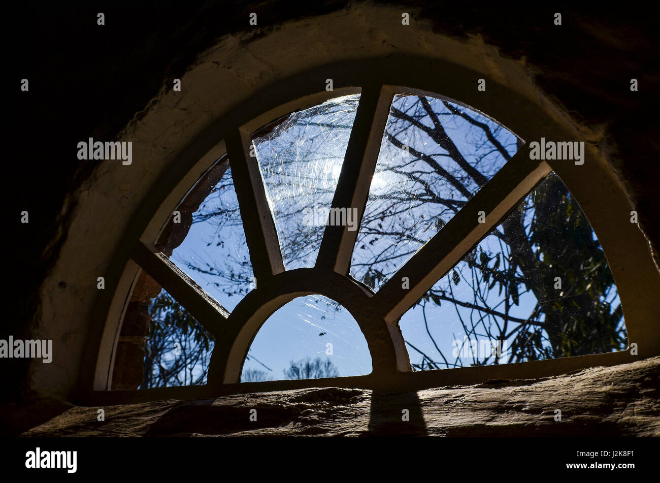 Small window opening in dark room to blue sky and trees Stock Photo - Alamy