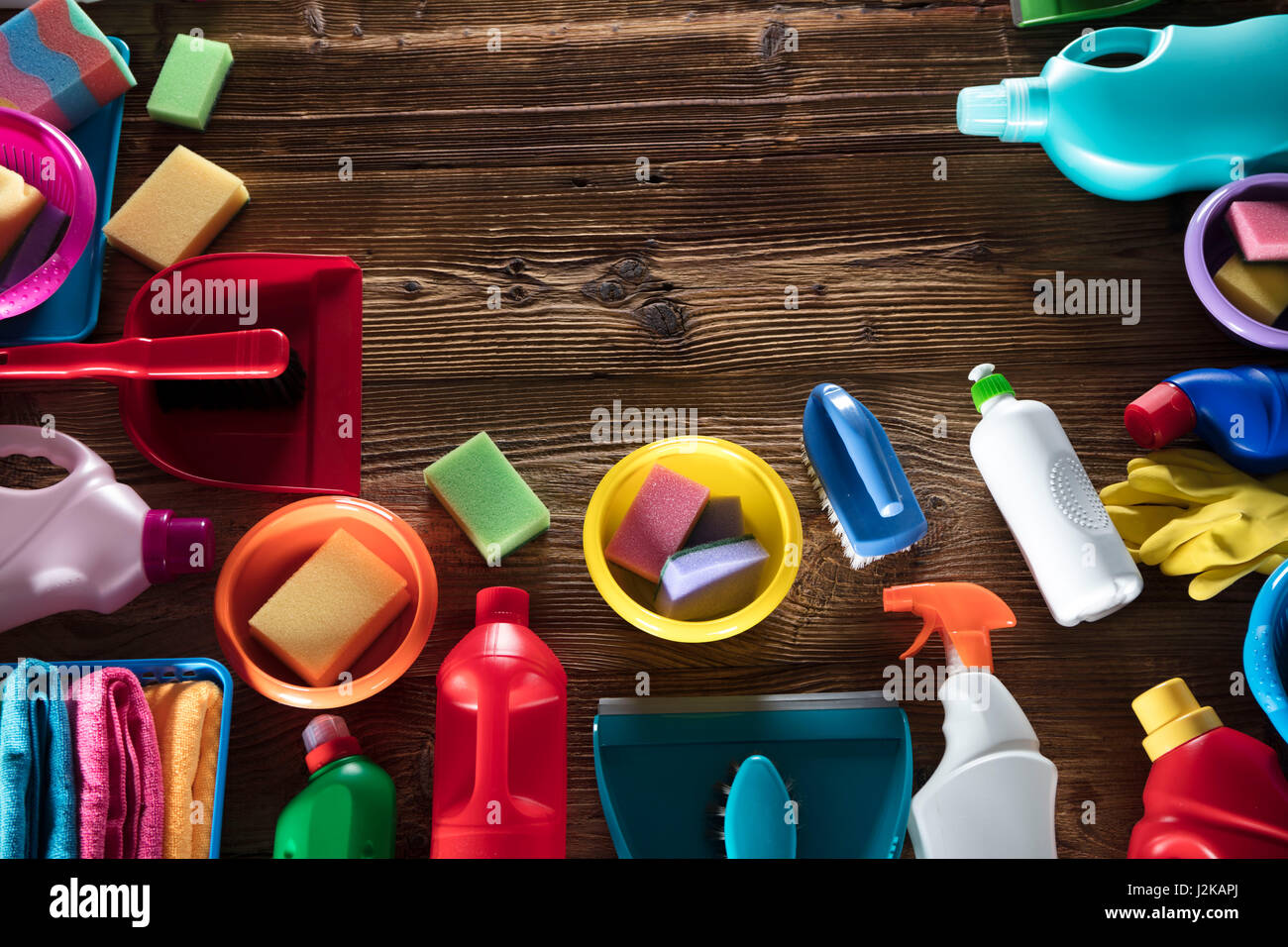 Spring cleanup theme. Variety of colorful house cleaning products on a ...