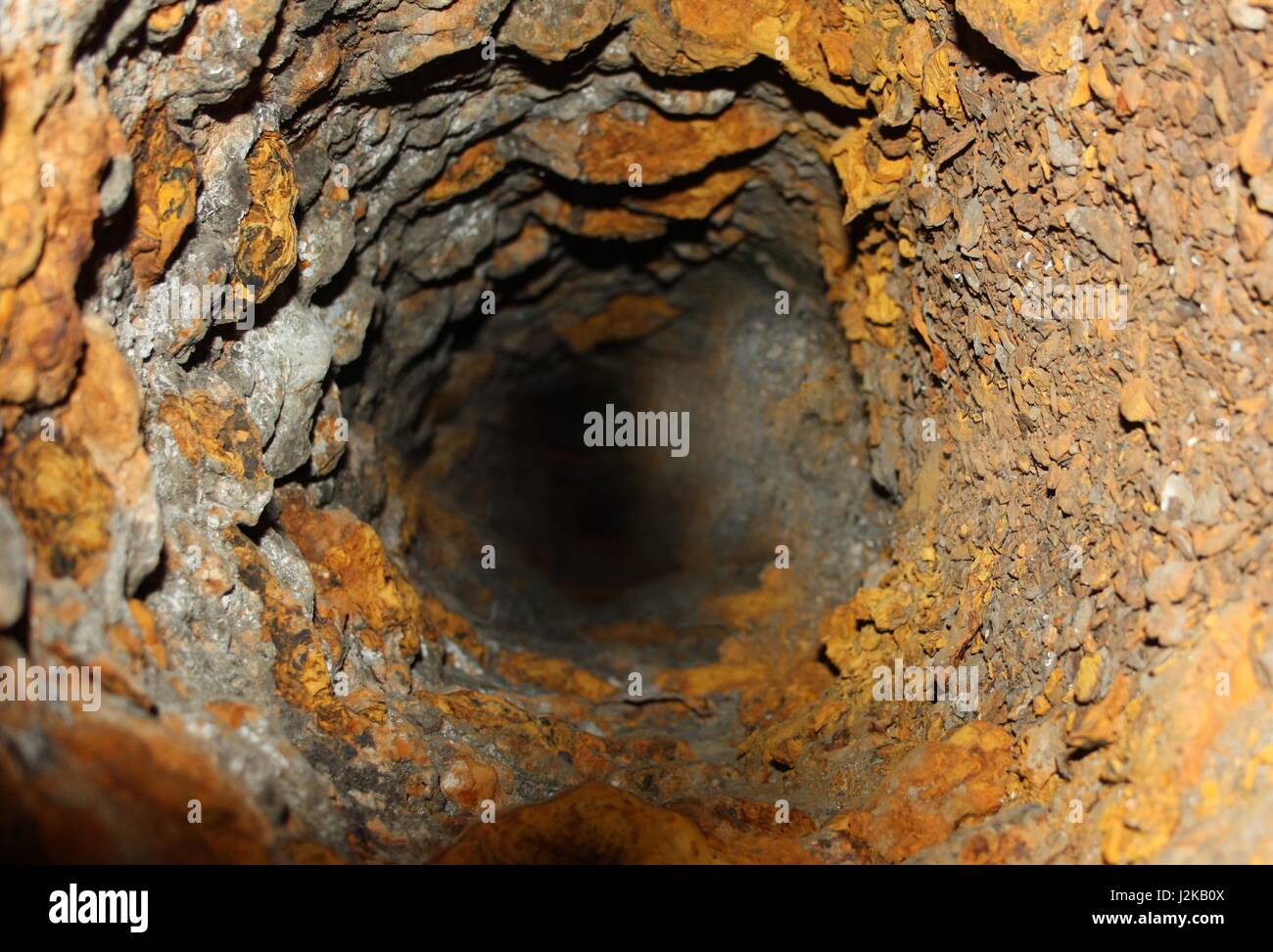 Metal erosion. Pipe in section. Old and tainted. abandoned building ...