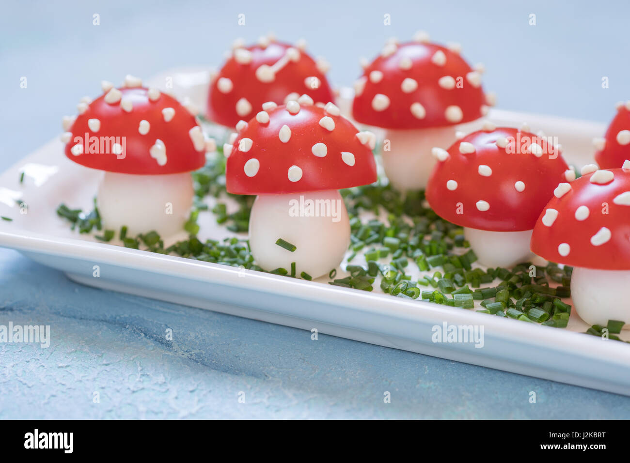 Tomato and egg appetizer look like amanita mushroom Stock Photo - Alamy