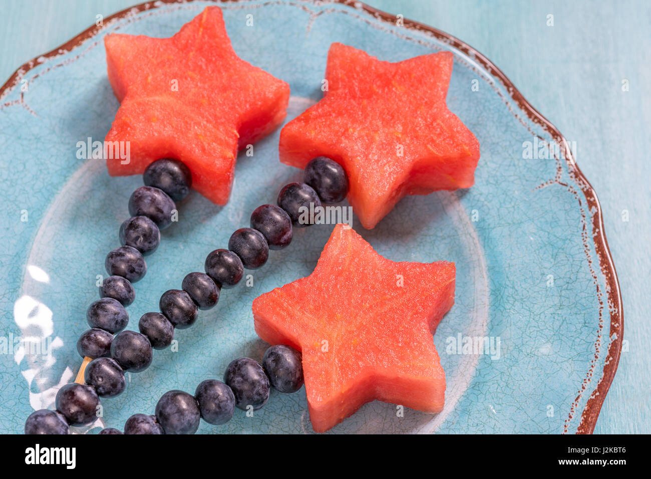 Watermelon stars with blueberry on a stick Stock Photo - Alamy