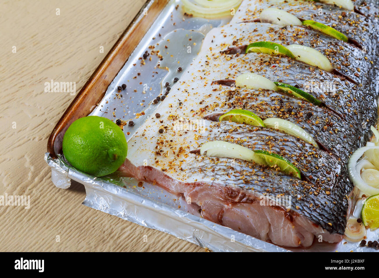 Marinated fried fish fry with spices n lemon filets in oil with lemon ...