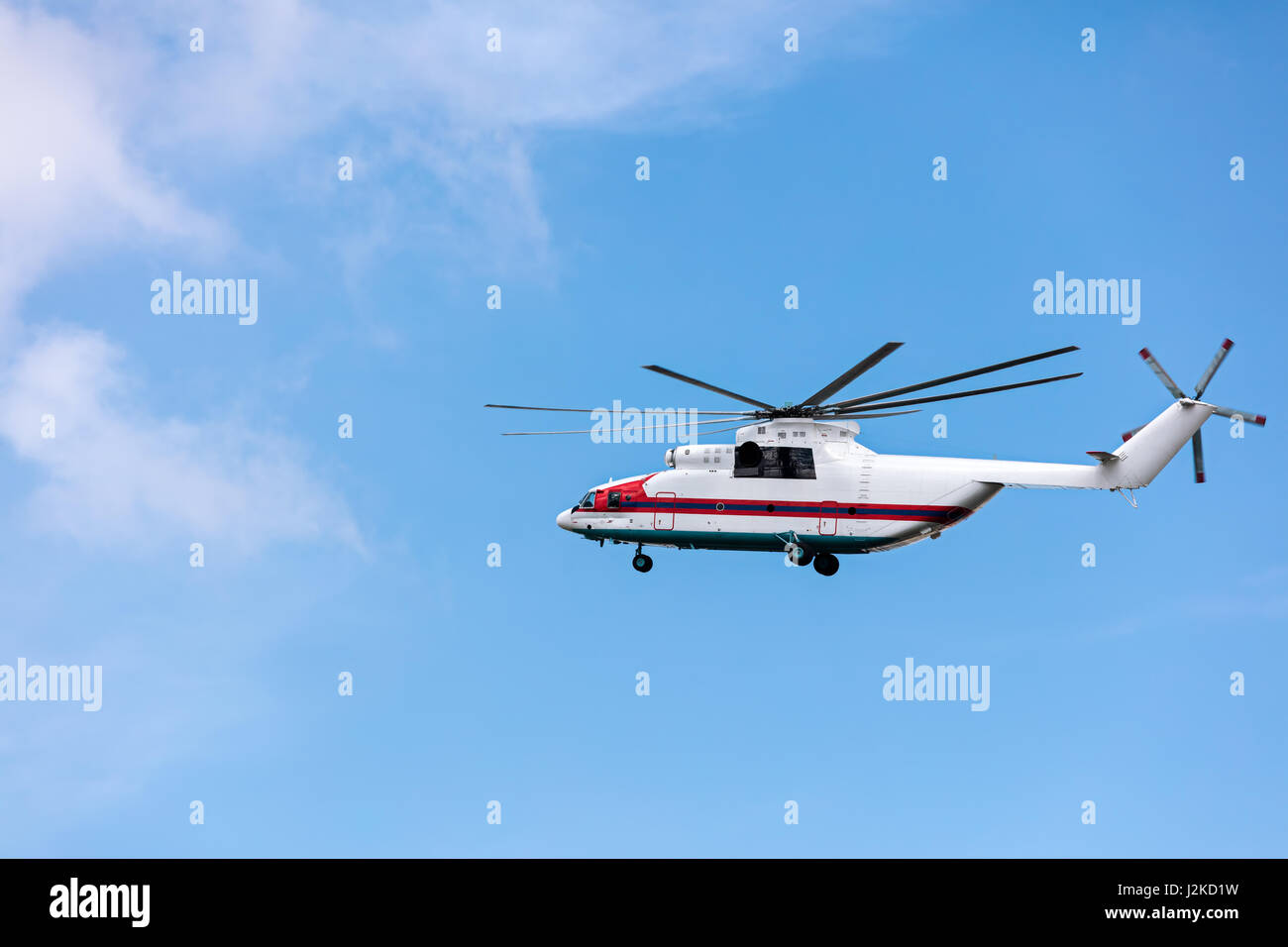 heavy cargo helicopter flying against blue sky Stock Photo - Alamy
