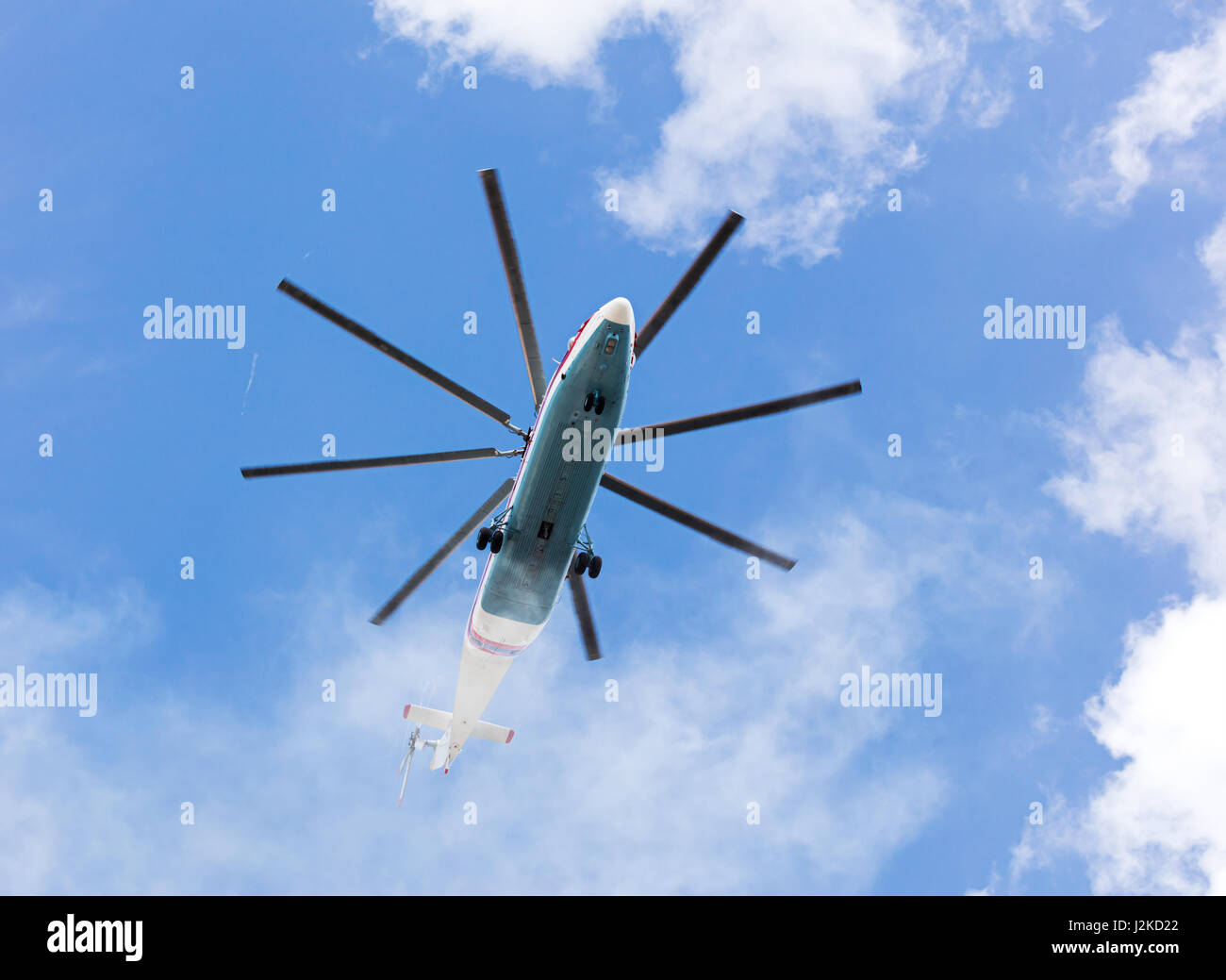heavy cargo helicopter flying overhead against blue sky Stock Photo - Alamy