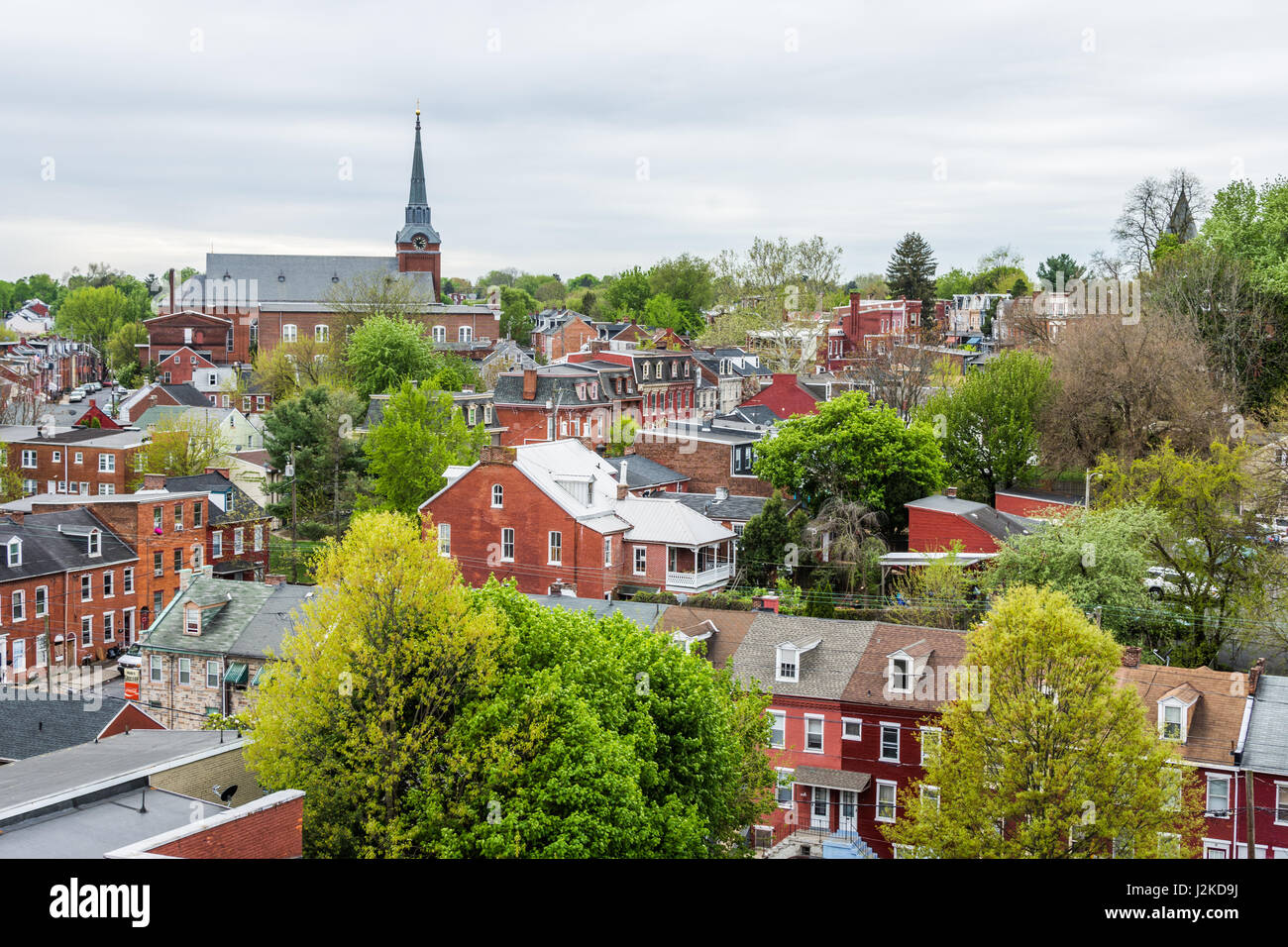 Aerial of historic downtown Lancaster, Pennsylvania with blooming trees ...
