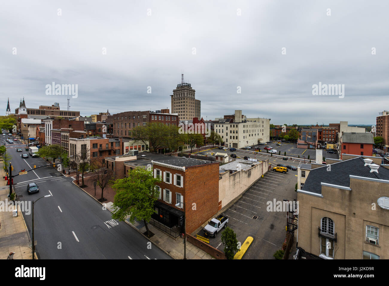 Aerial of historic downtown Lancaster, Pennsylvania with blooming trees ...