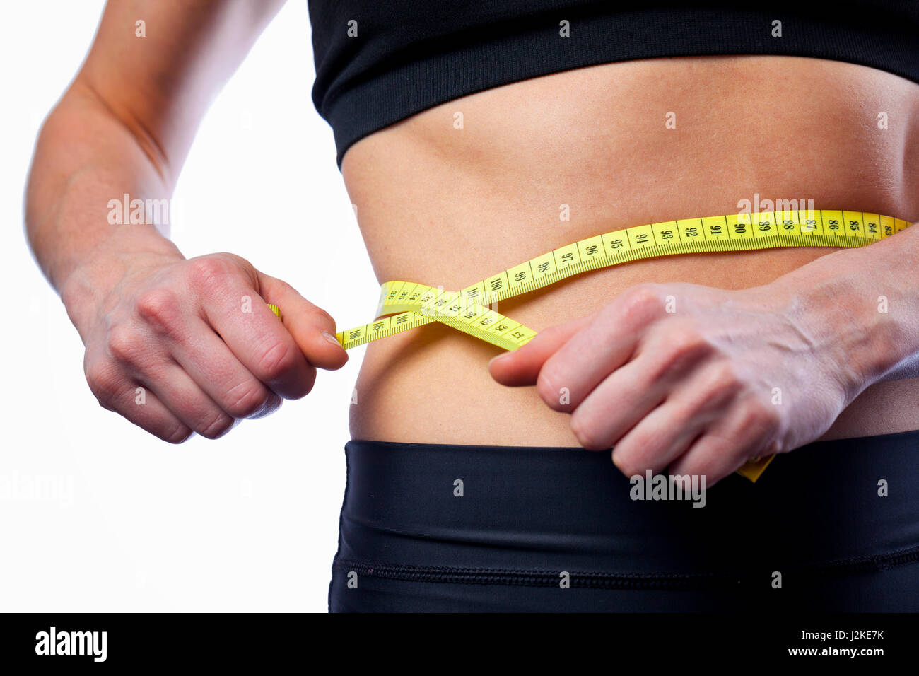 fit woman measuring waist Stock Photo - Alamy