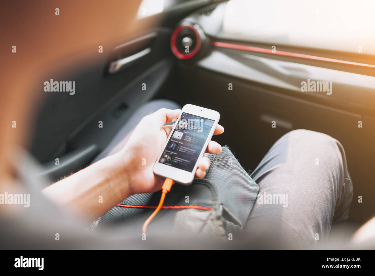 Man connecting phone to the car media system Stock Photo - Alamy