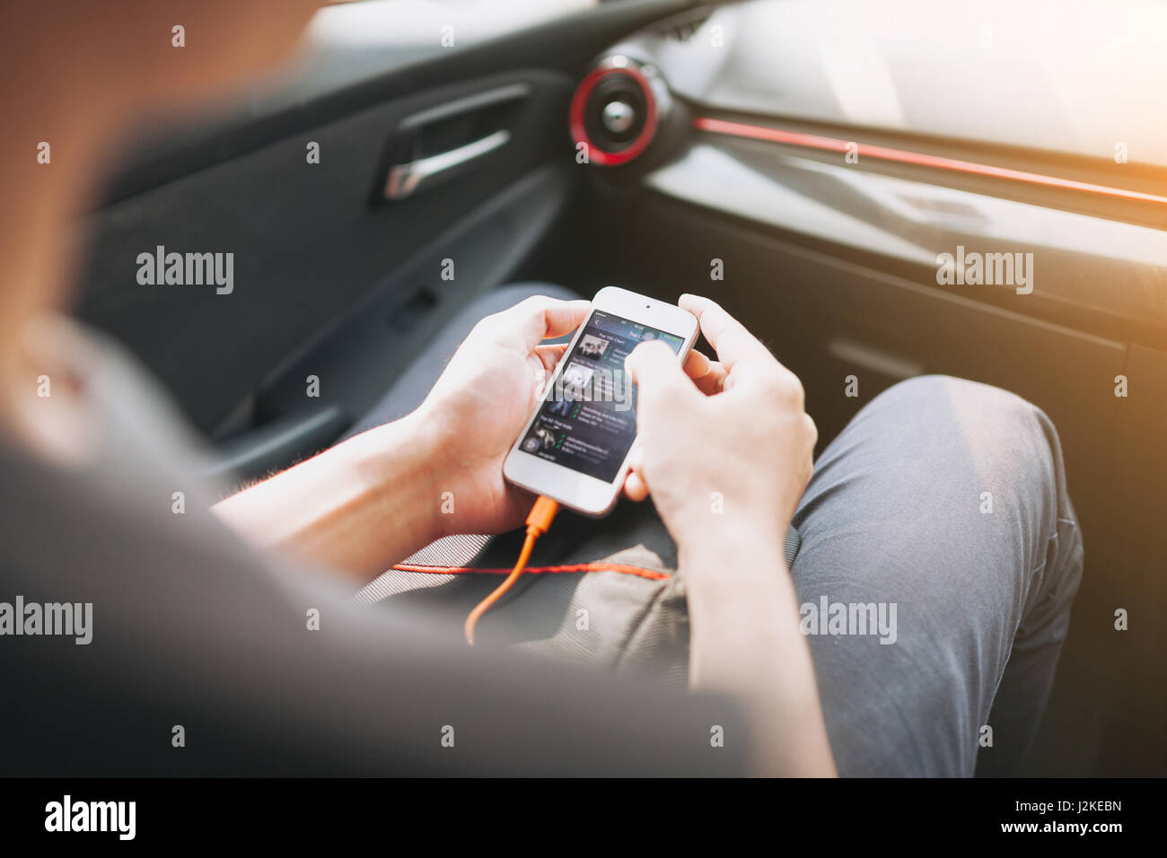 Man connecting phone to the car media system Stock Photo - Alamy