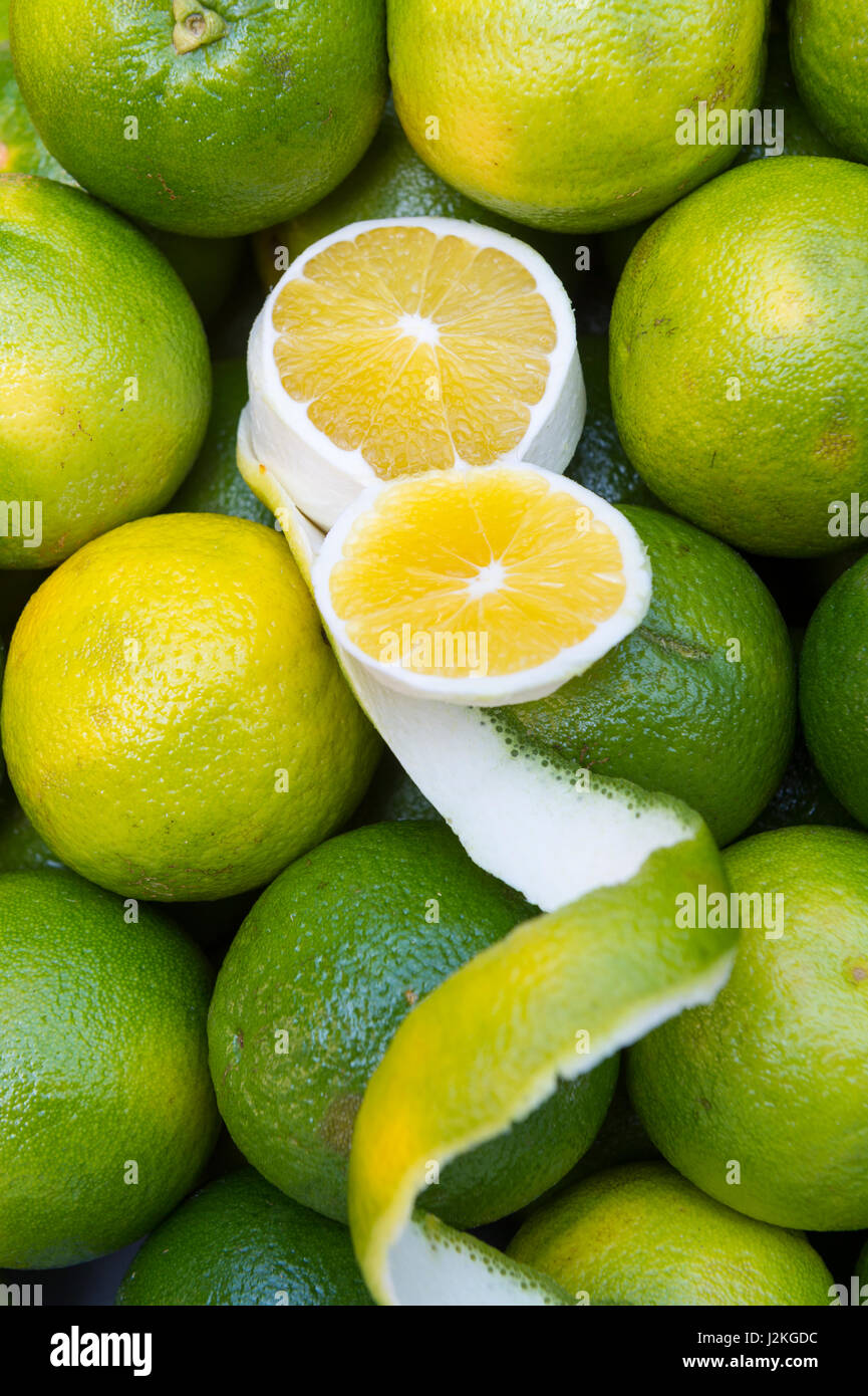 Fresh Brazilian limes (limão) cut open with a decorative flourish at an ...