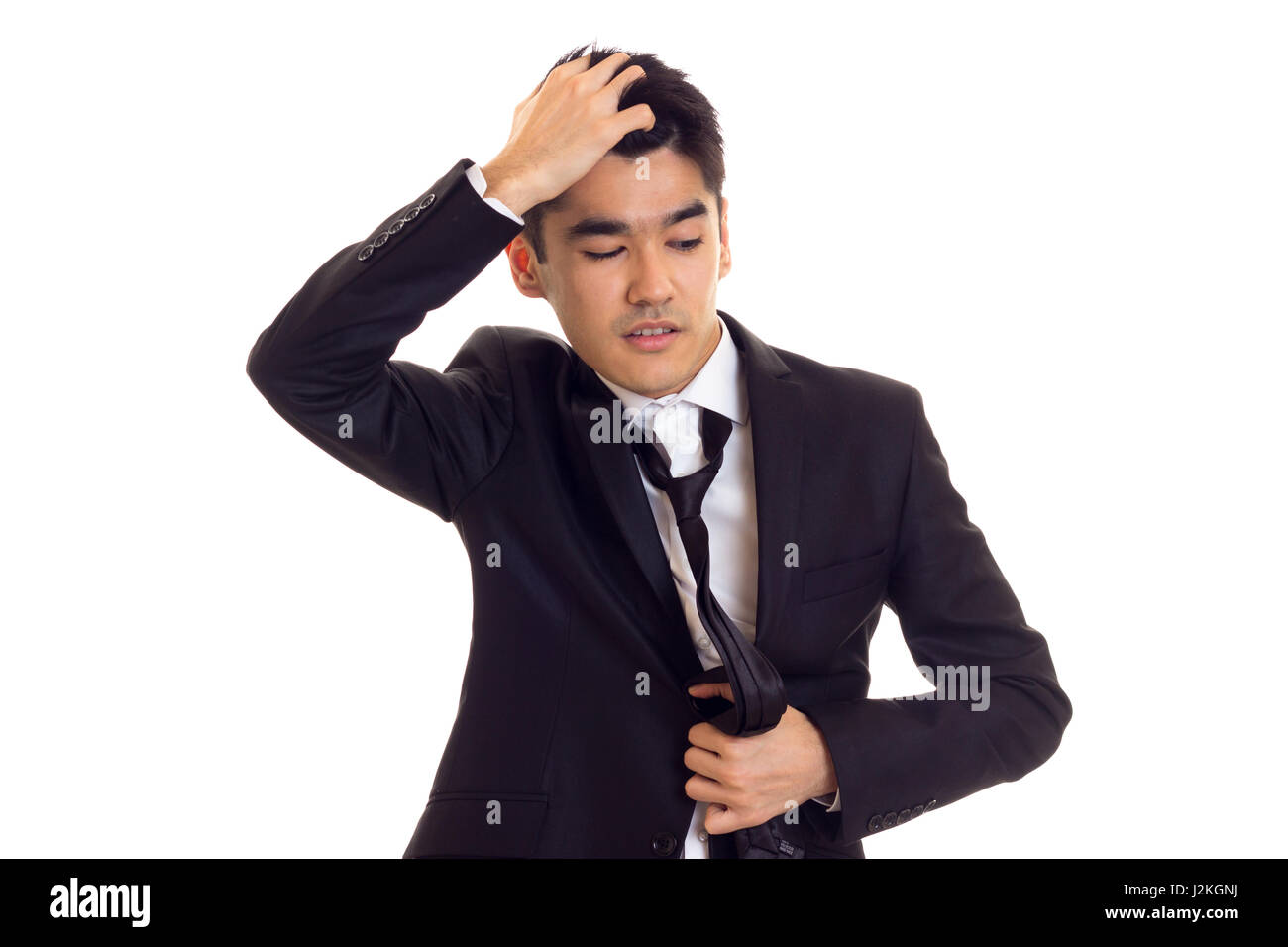 Young smart-looking man with black hair in white shirt and black tuxedo ...