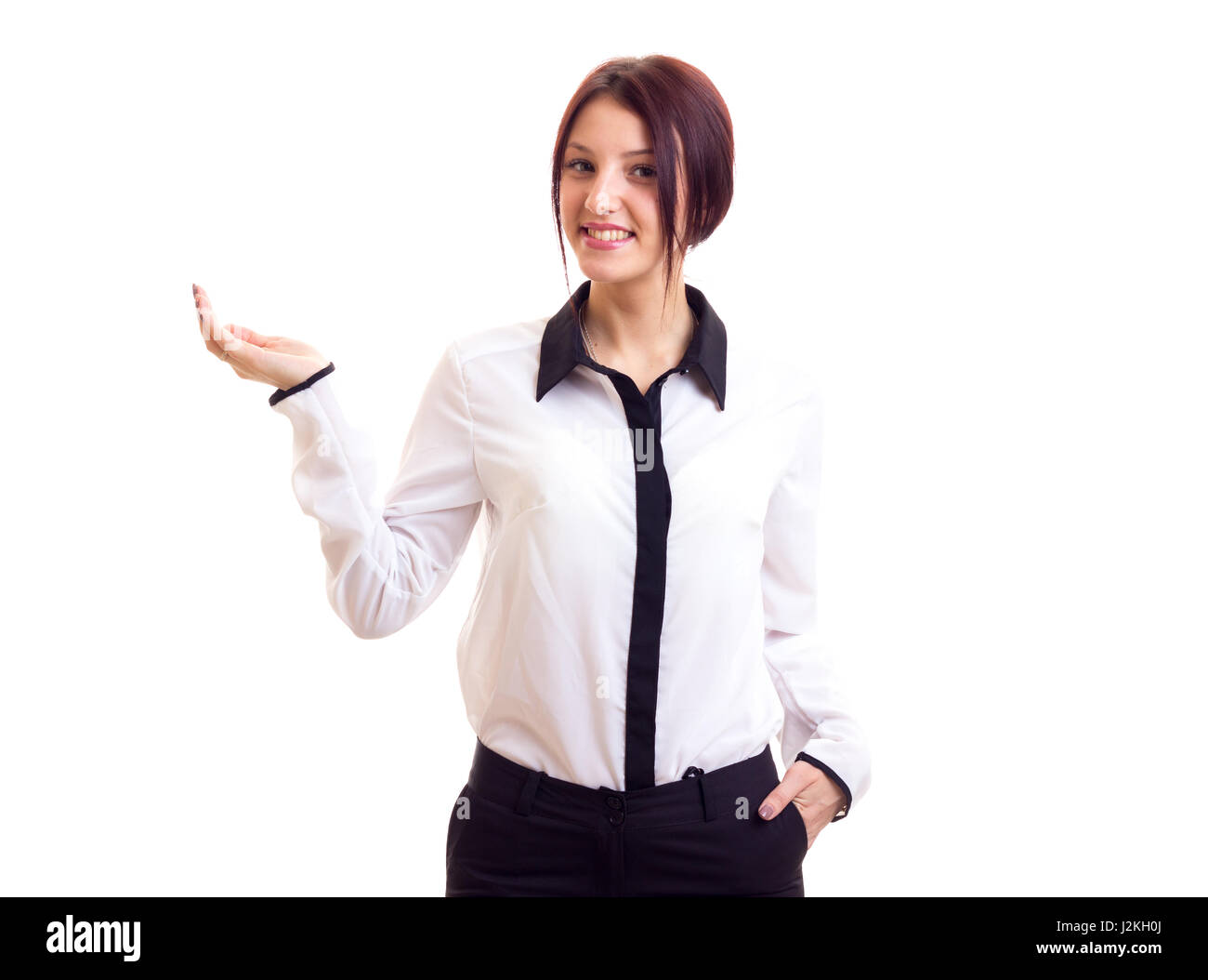 Smiling young woman in white shirt and black trousers with ponytail on ...