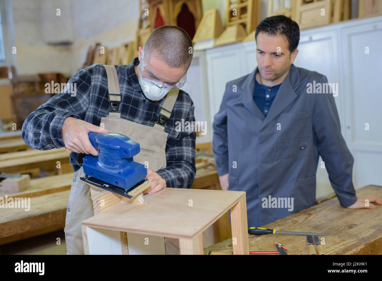 student sanding wood in carpentry lesson Stock Photo - Alamy