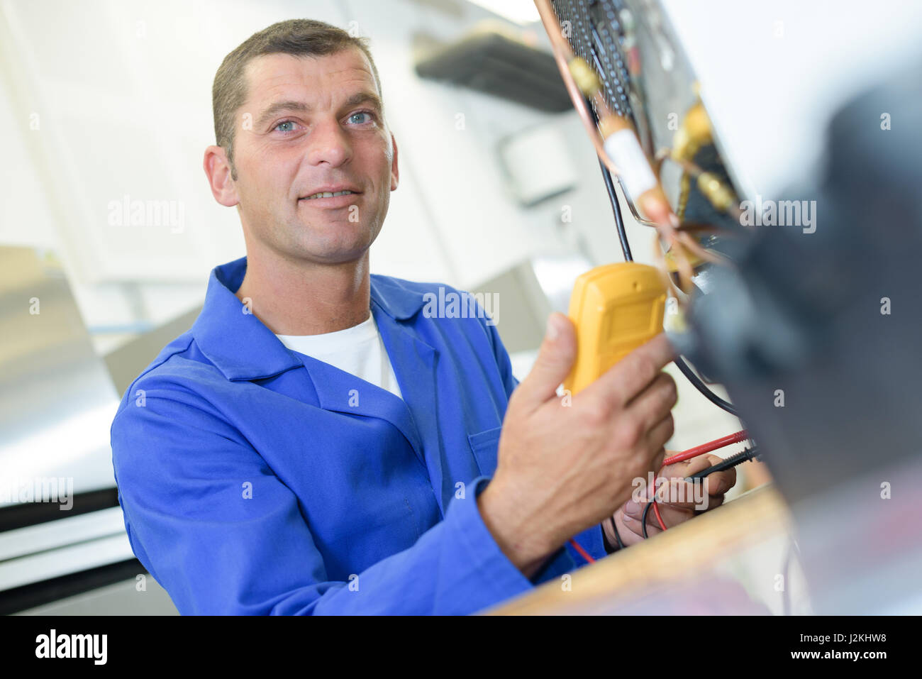 Portrait of man with multimeter Stock Photo - Alamy