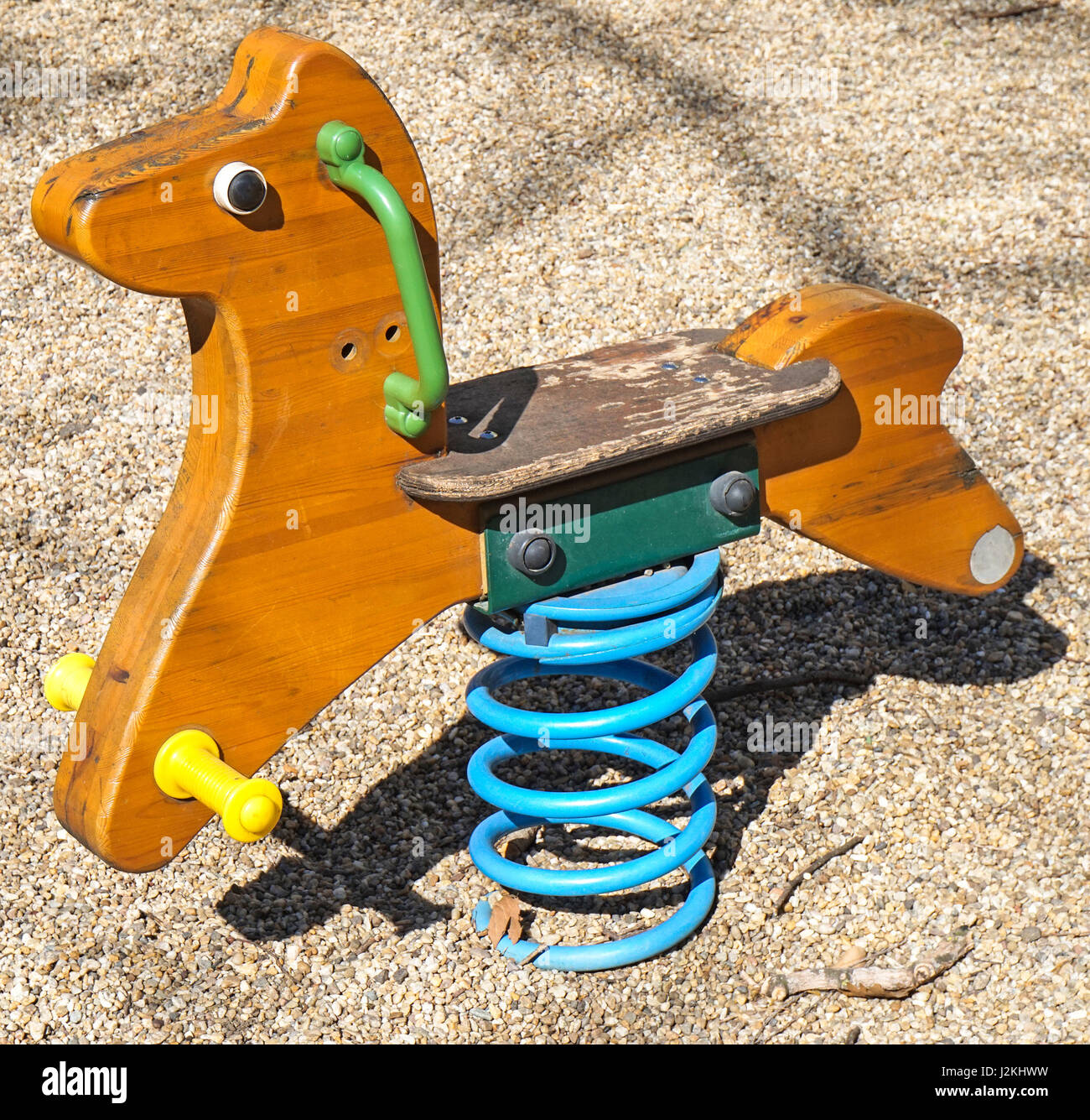 Horse shaped teeter at the playground Stock Photo - Alamy